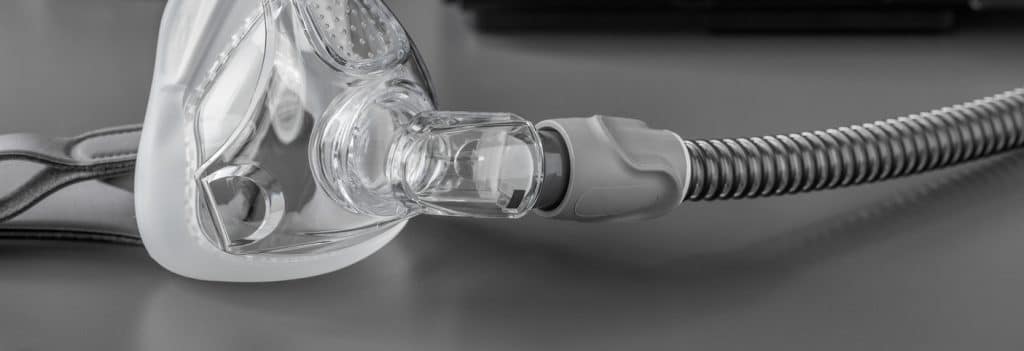 Sleep apnea CPAP mask on the grey table - Sleep Dynamics