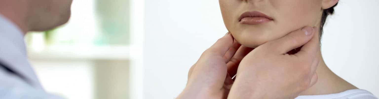 Male physician checking patient throat and neck, health examination in ...