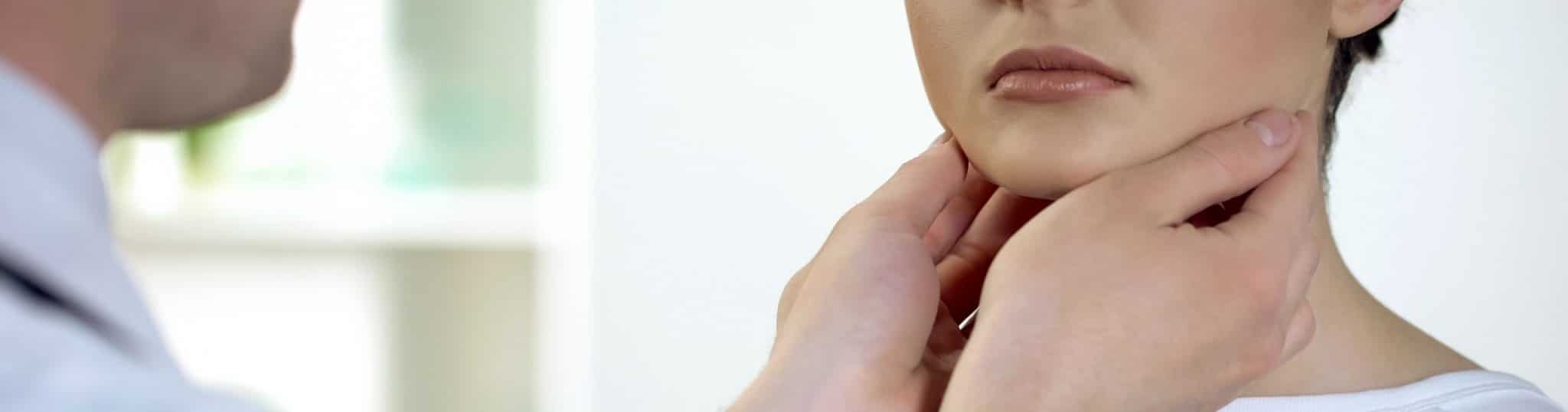 Male physician checking patient throat and neck, health examination in ...